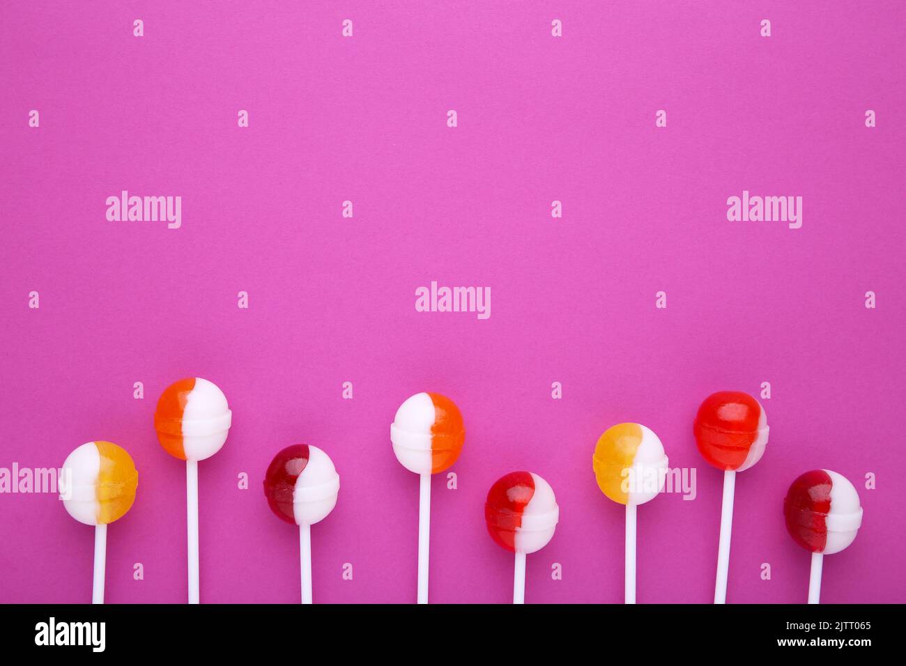 Sweet colorful lollipop on pink background Stock Photo - Alamy