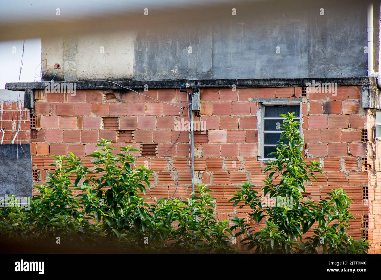 red brick wall, very common in the slum in Rio de Janeiro and Brazil ...