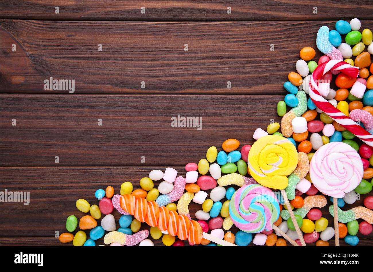 Colorful lollipops and different colored round candy on brown Stock ...