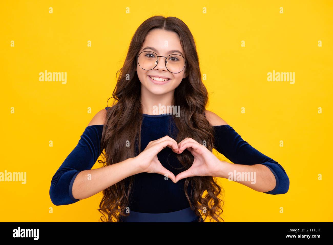 Child hands making sign heart by fingers. Valentines Day. Dreaming cute ...