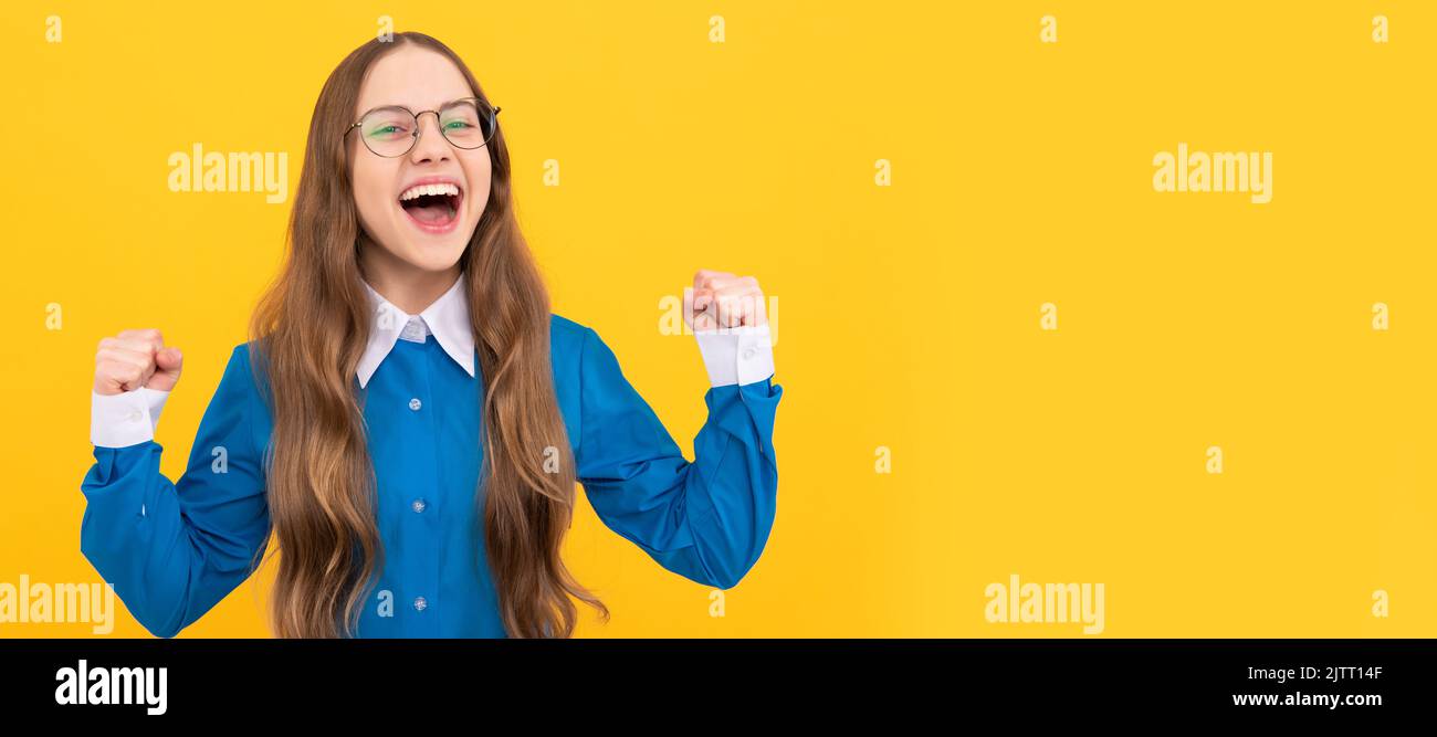 Happy back to school child show winning gesture yellow background ...