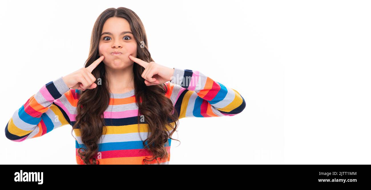 Funny face. Beautiful teen child pinching cheeks with index finger ...