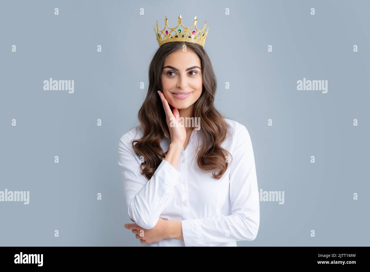 Pretty young woman wear crown, isolated on gray background. Girl with ...