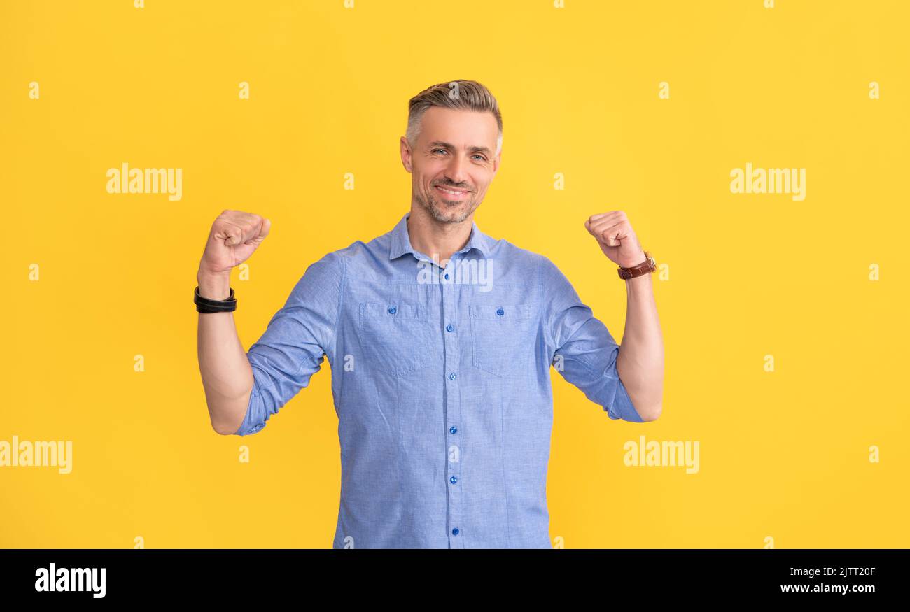 happy successful man with wristwatch on yellow background, success ...