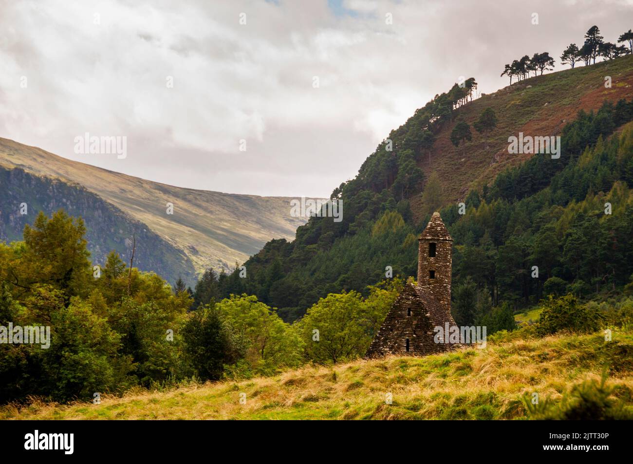 Stone roof and round belfry of St. Kevins KItchen in Glendalough ...