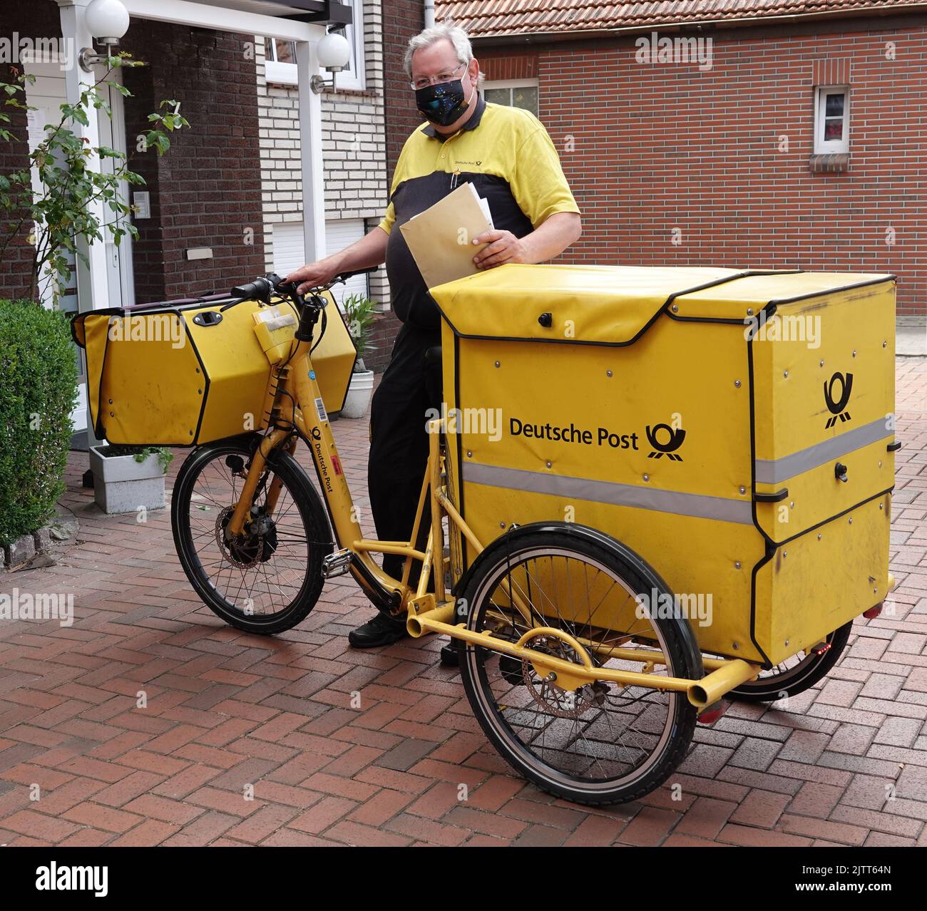 Papenburg, Germany - June 17 2022 A friendly postal worker from the ...