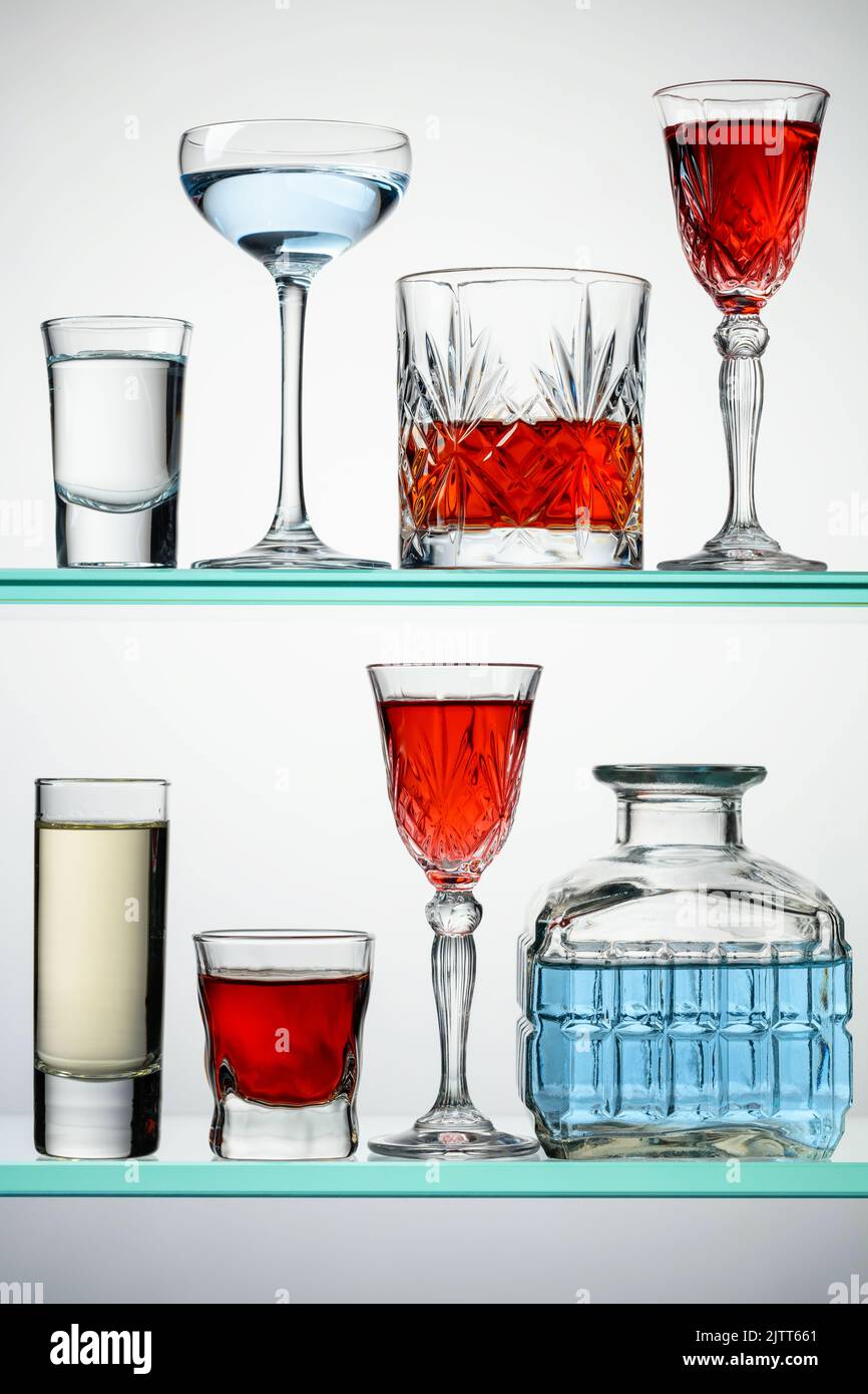 Various alcoholic drinks in the bar on glass shelves Stock Photo - Alamy