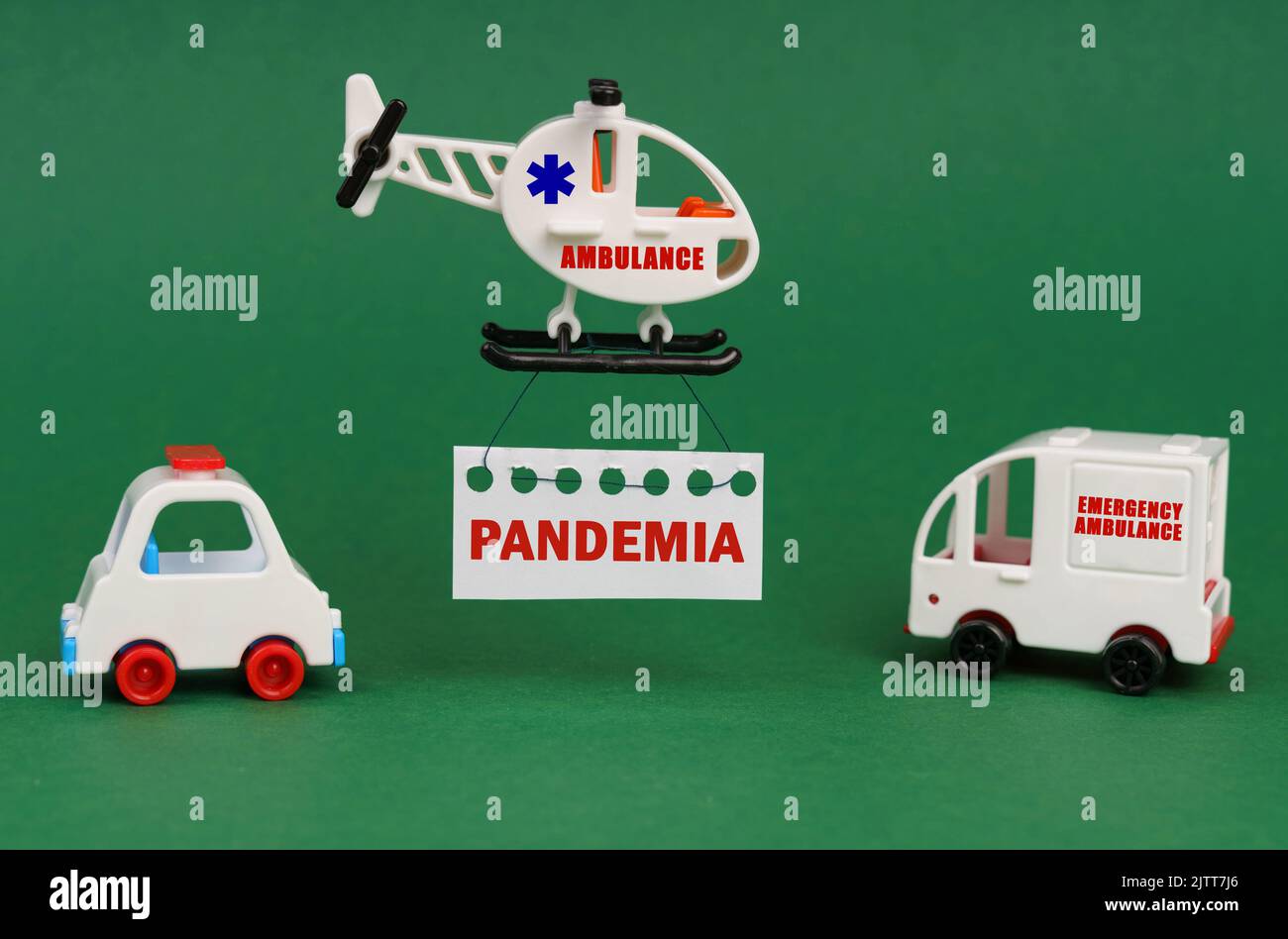 Medical concept. On a green surface, cars and an ambulance helicopter ...