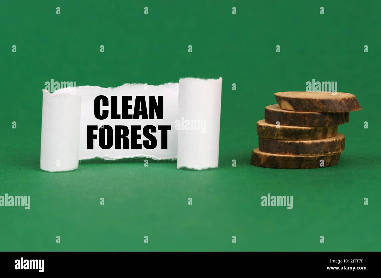 Ecological concept. On a green surface, wooden circles and a white ...
