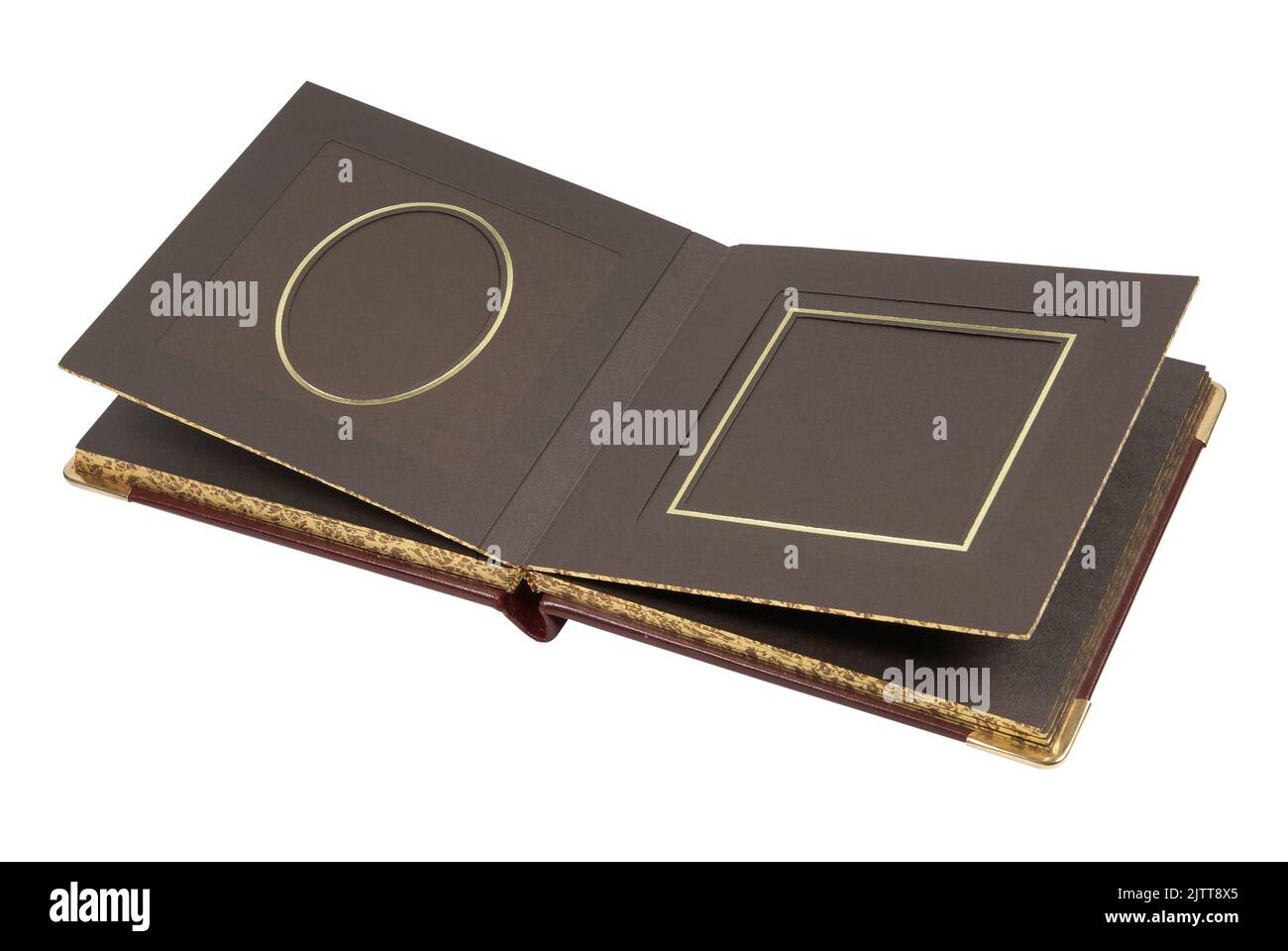 An empty photograph album, opened. Gold edging on spine and photo ...