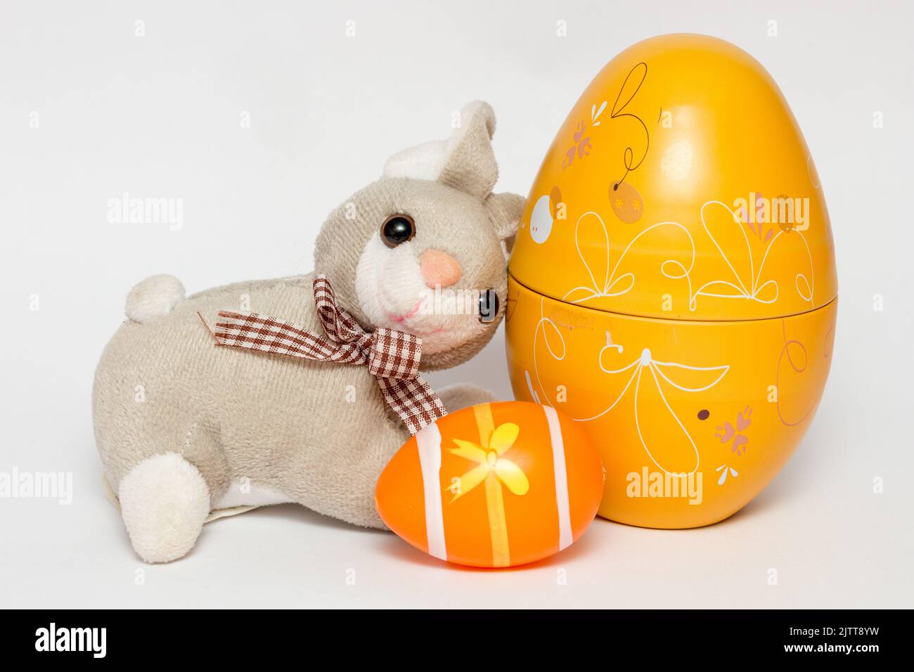 yellow and orange plastic eggs with a plush rabbit, used for Easter ...
