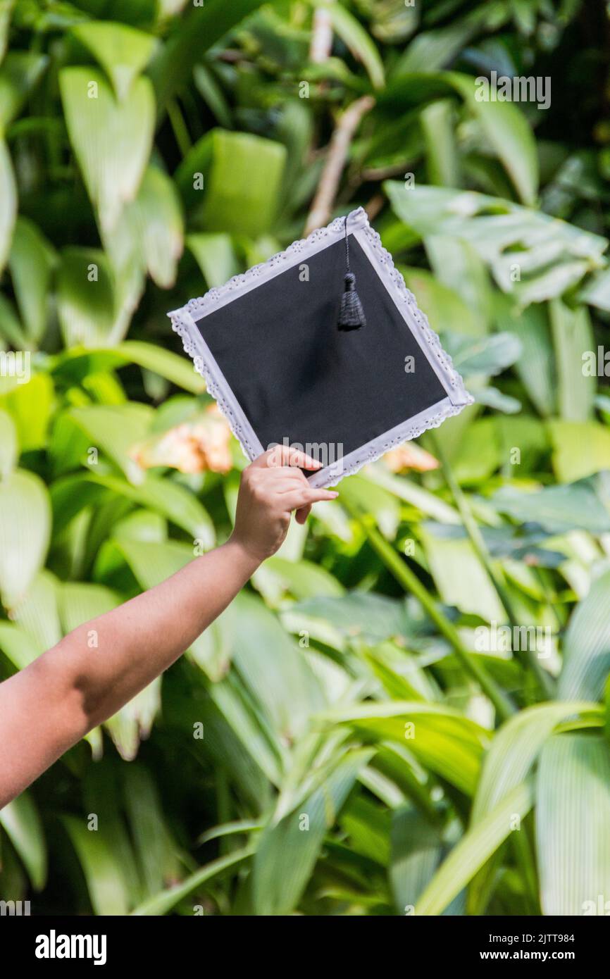 hand holding graduate hat in rio de janeiro Stock Photo - Alamy