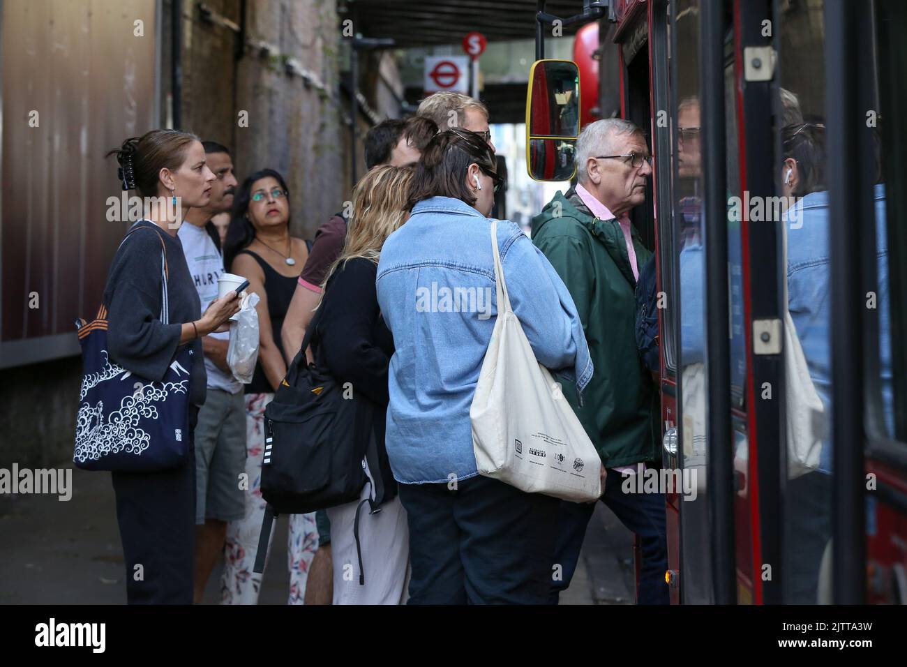 Commuters seen boarding a London transport bus Stock Photo - Alamy