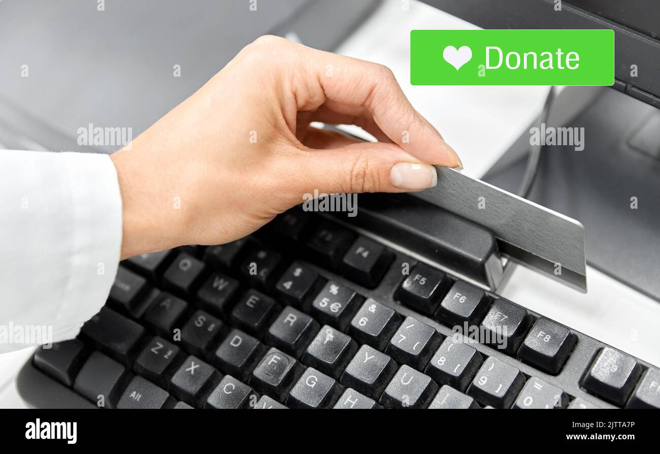 hand with credit card making donation online Stock Photo - Alamy
