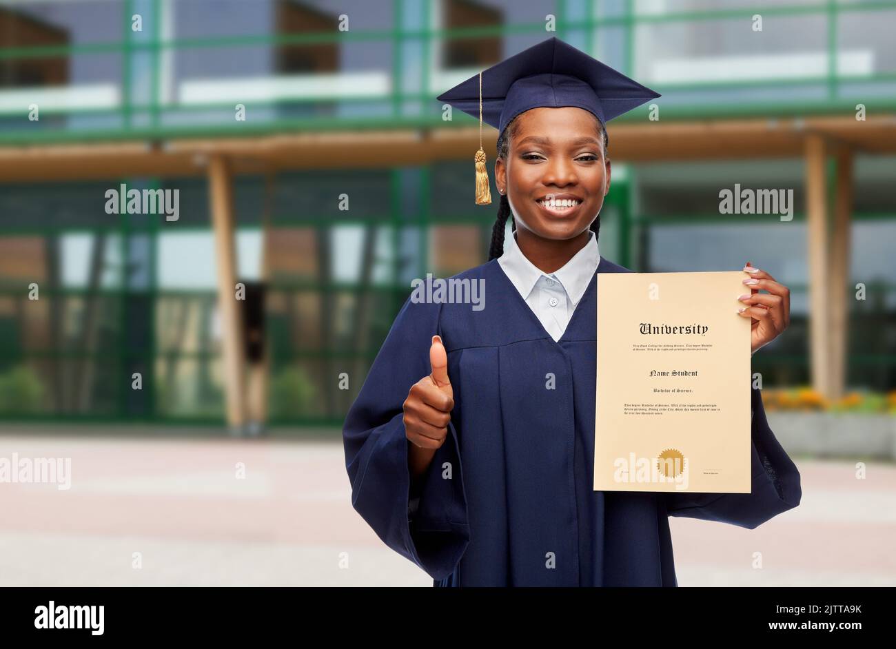 graduate student with diploma showing thumbs up Stock Photo - Alamy