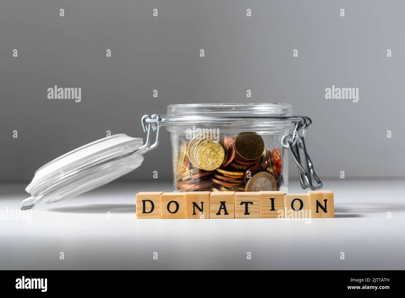 coins in glass jar for donation Stock Photo - Alamy