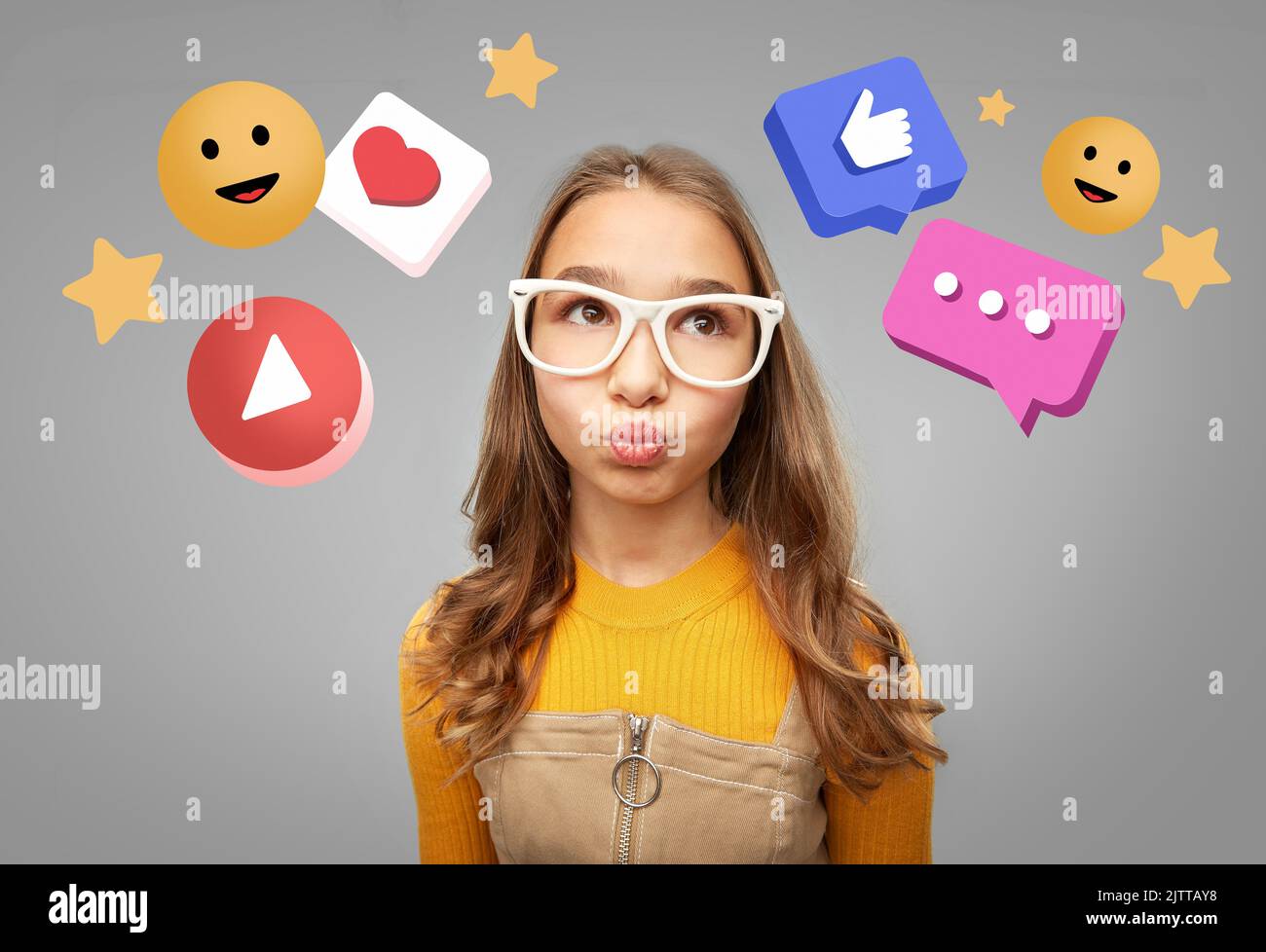 teenage girl in glasses looking at internet icons Stock Photo - Alamy