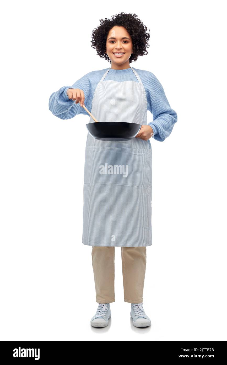 happy woman in apron cooking food in frying pan Stock Photo - Alamy