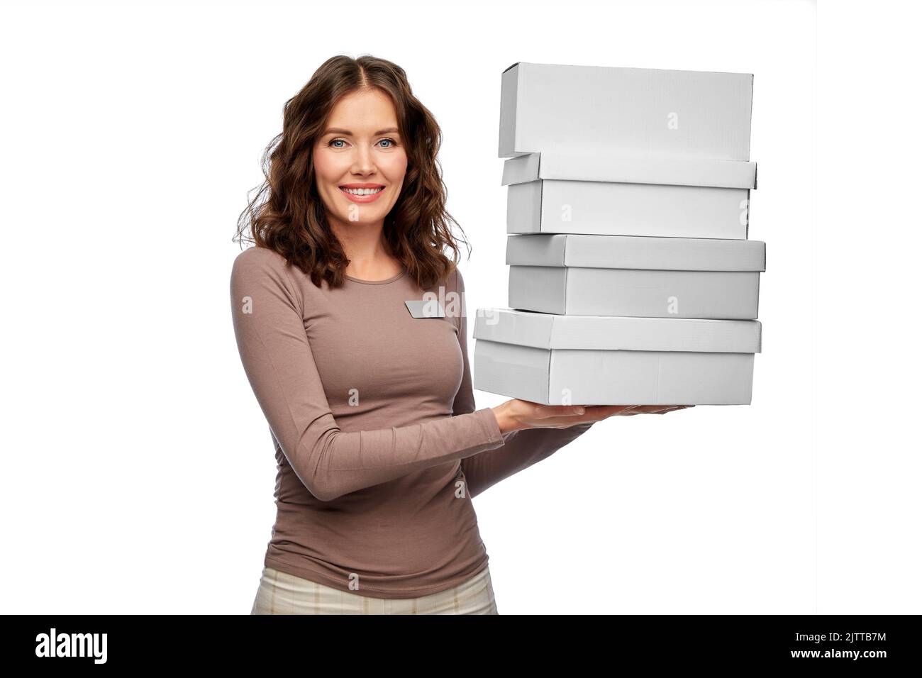 happy female shop assistant holding shoe boxes Stock Photo - Alamy