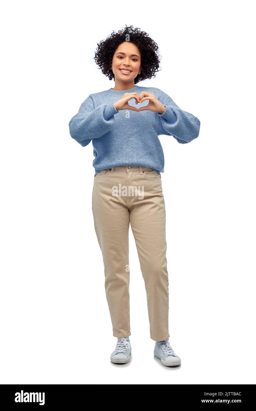 happy woman in sweater showing hand heart gesture Stock Photo - Alamy