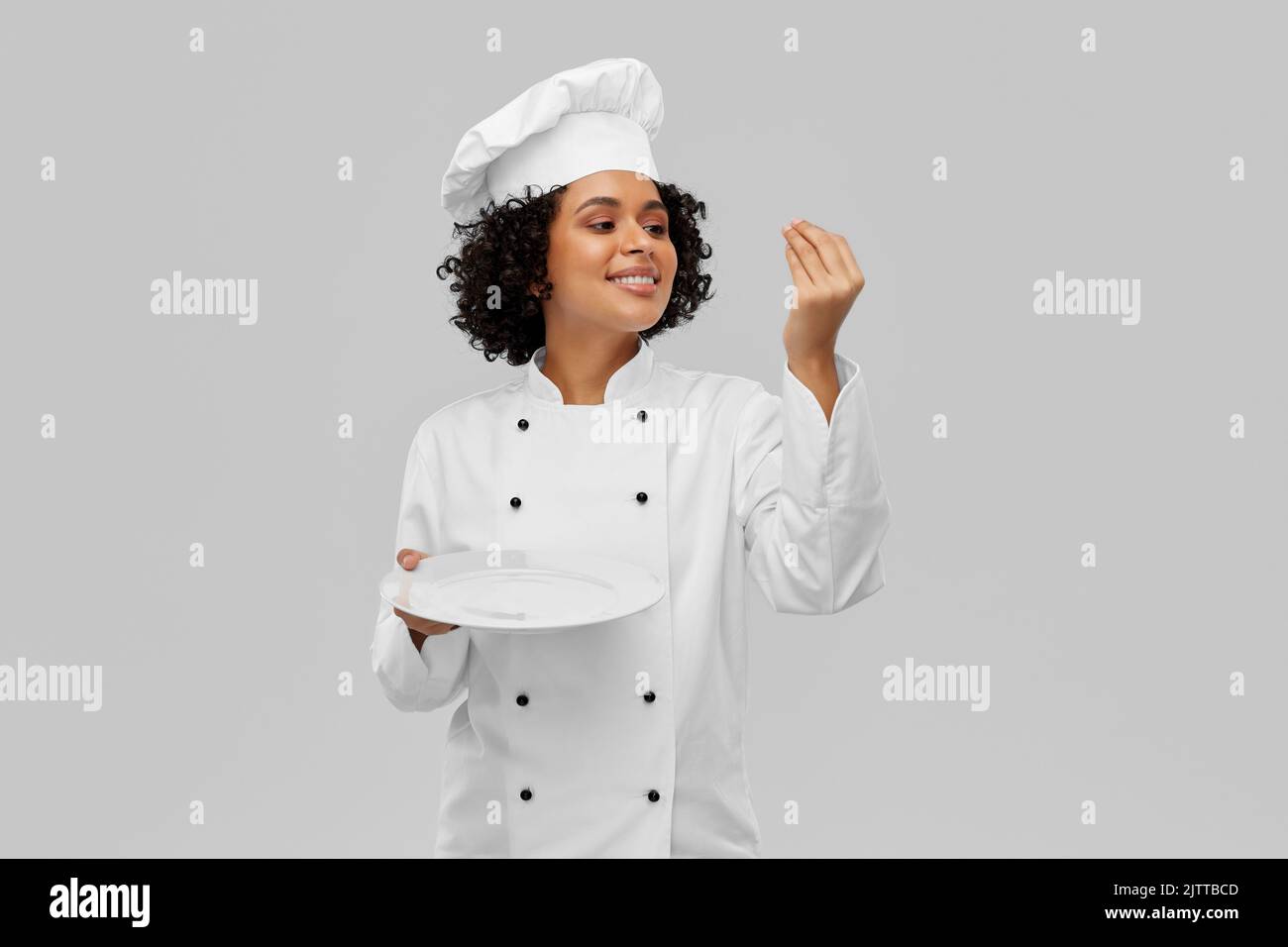 happy smiling female chef holding empty plate Stock Photo - Alamy