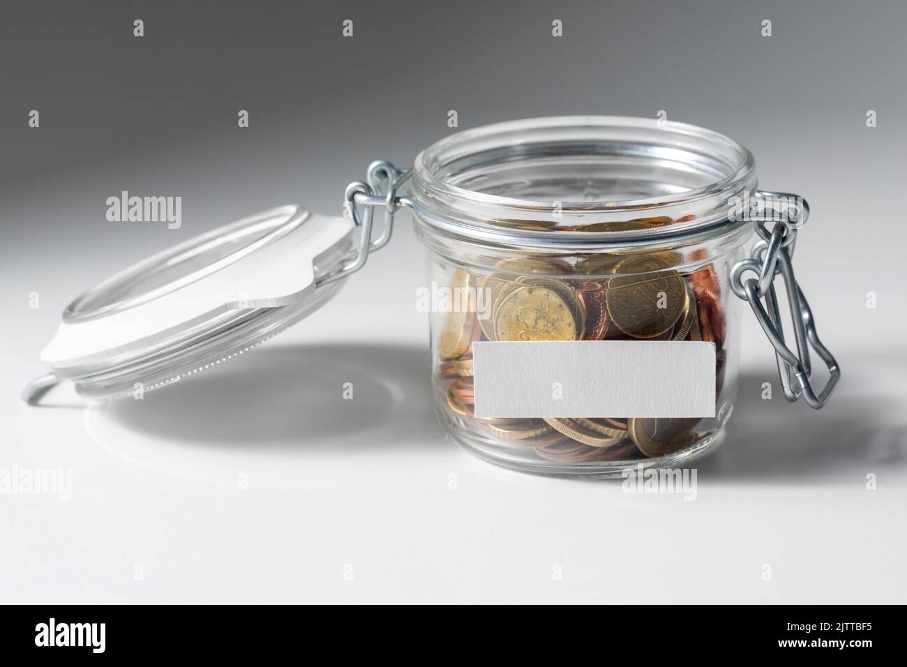 coins in glass jar for donation or saving Stock Photo - Alamy