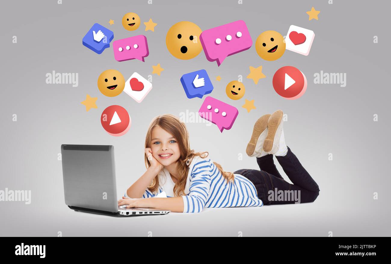 smiling girl with laptop and internet icons Stock Photo - Alamy