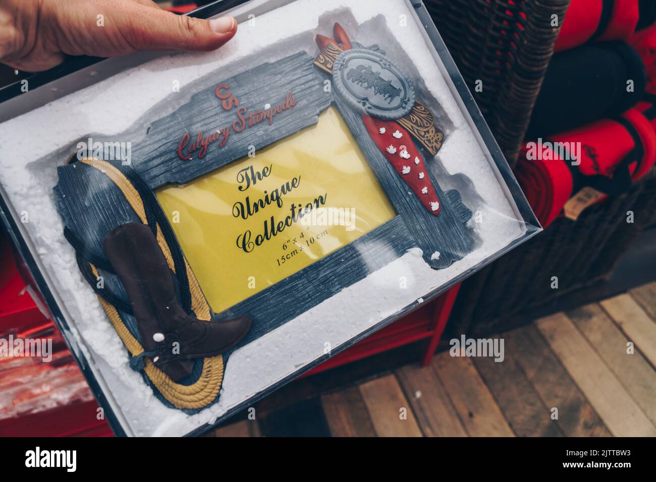 Calgary, Alberta, Canada - July 16, 2022: Hand holds up a picture frame ...