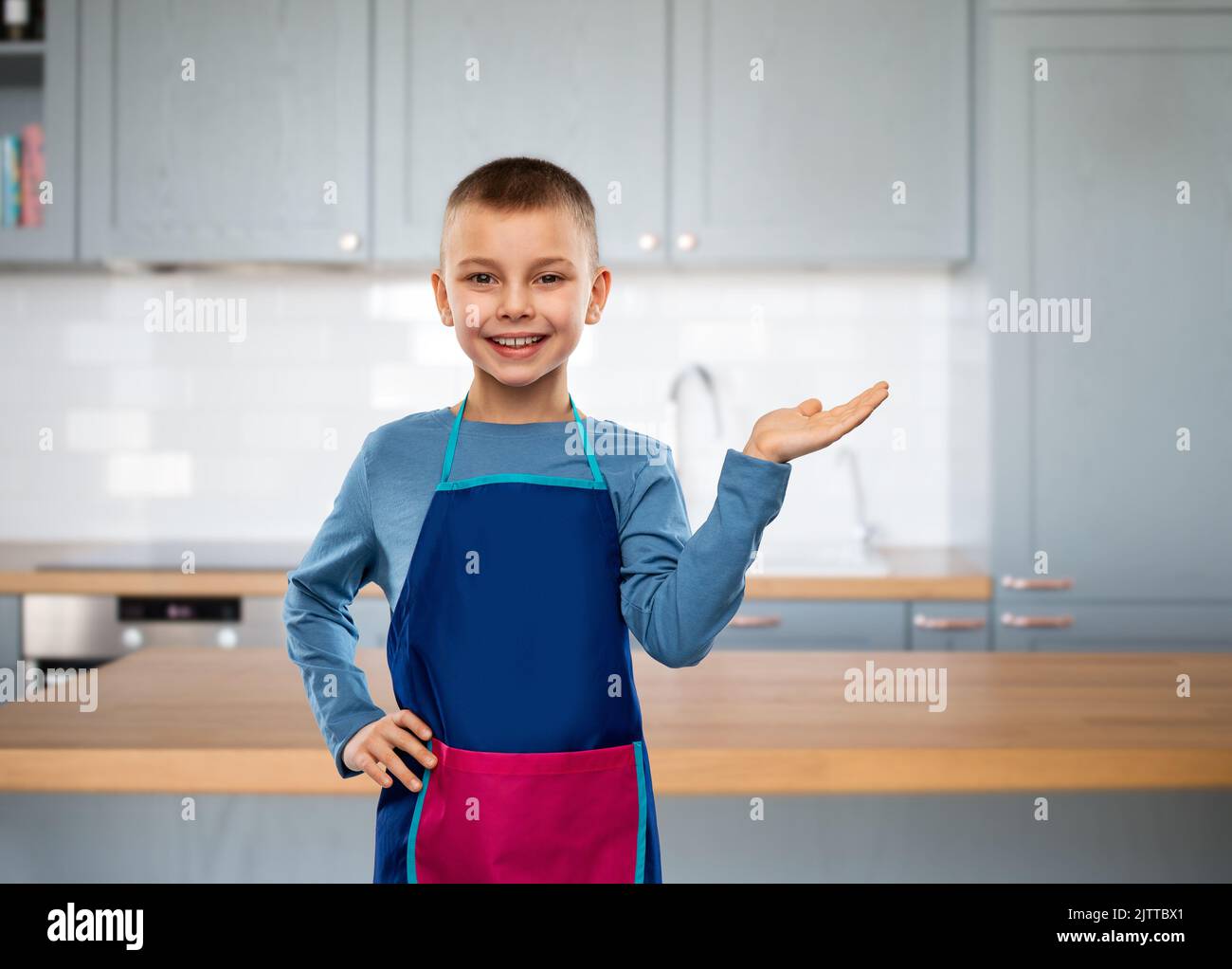 little boy in apron holding something on hand Stock Photo - Alamy