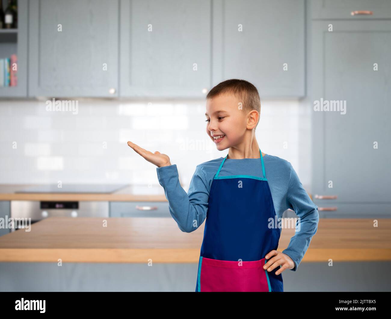 little boy in apron holding something on hand Stock Photo - Alamy