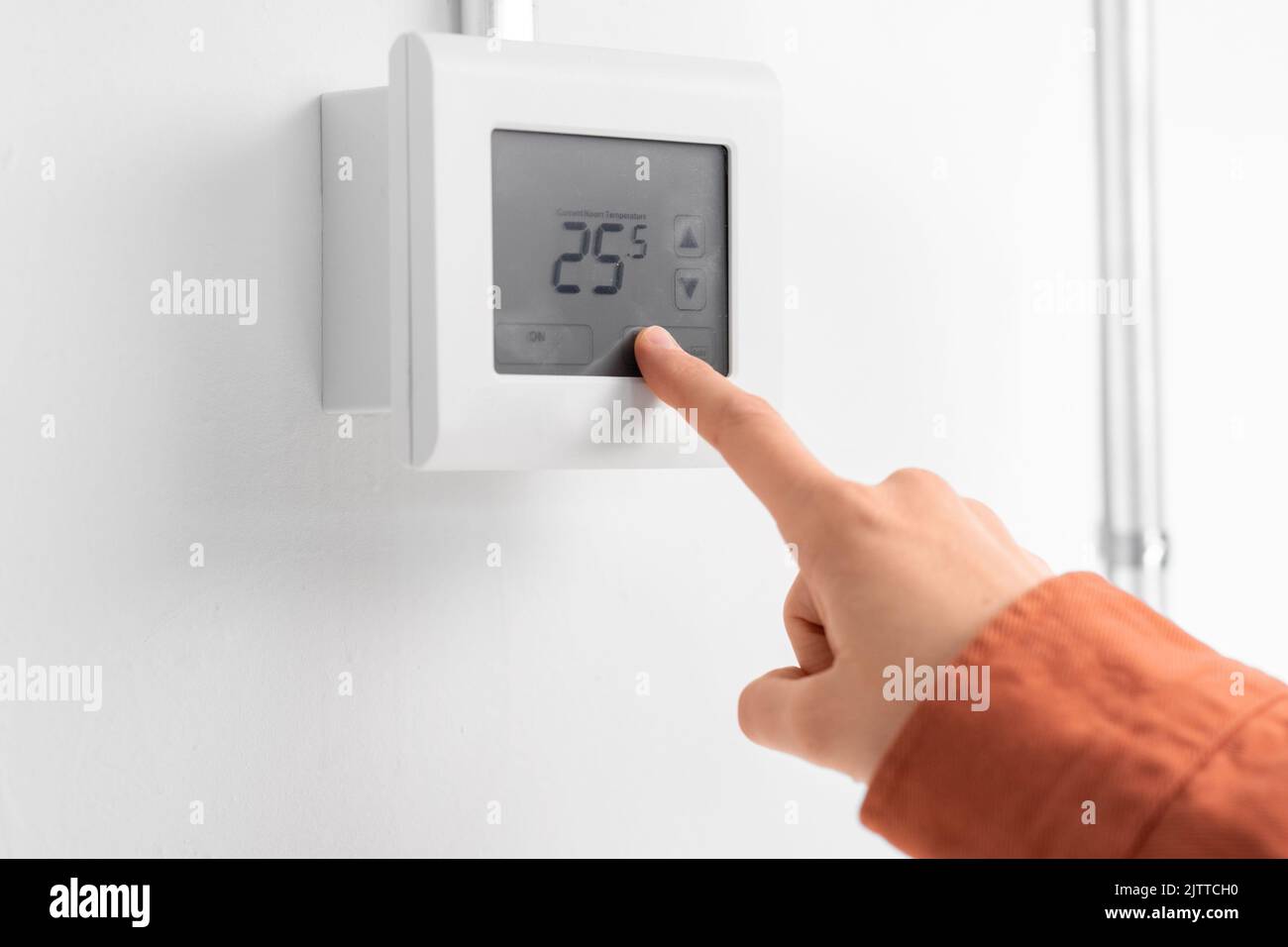 hand setting room temperature on sensor at home Stock Photo - Alamy