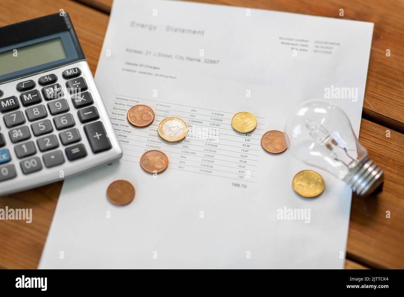 utility bill, calculator, money and lightbulb Stock Photo - Alamy