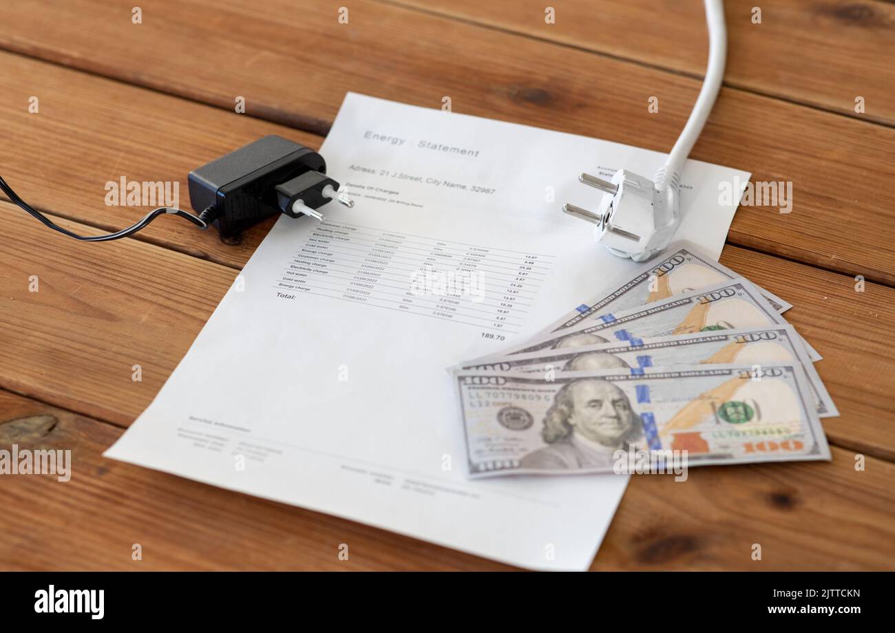 utility bill, money and electric plugs on table Stock Photo - Alamy