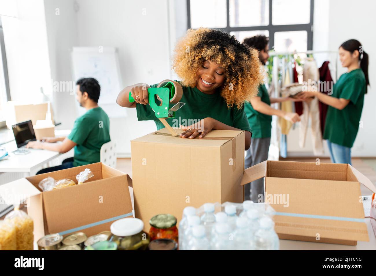 happy volunteers packing food in donation boxes Stock Photo - Alamy