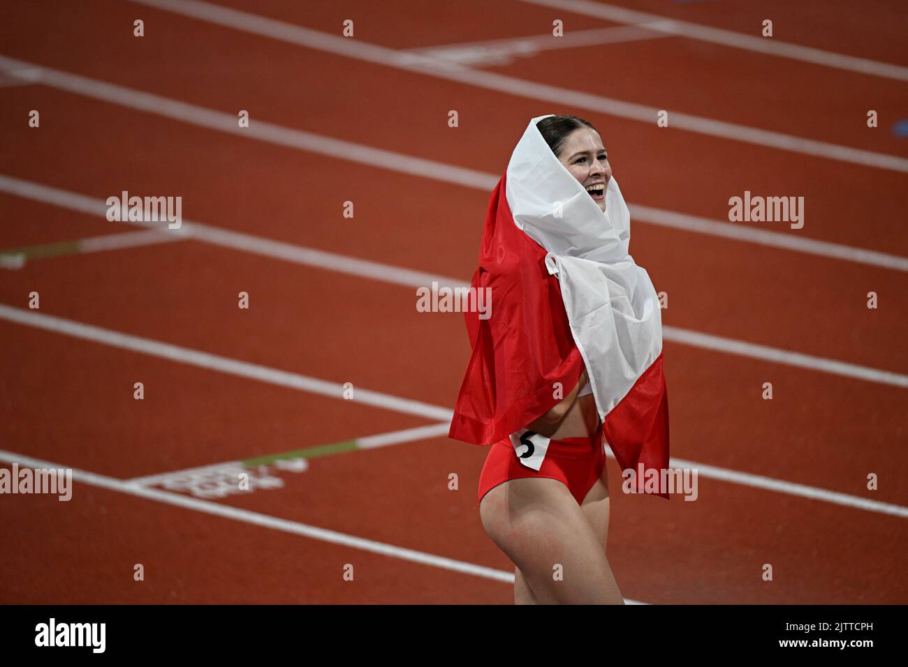 Pia Skrzyszowska with her country's flag as the winner of the 100 ...