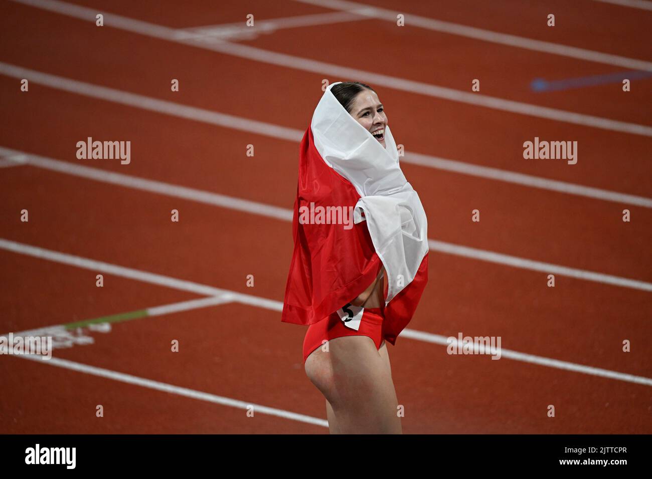 Pia Skrzyszowska with her country's flag as the winner of the 100 ...