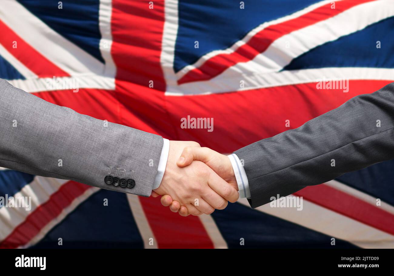 handshake over flag of united kingdom Stock Photo - Alamy