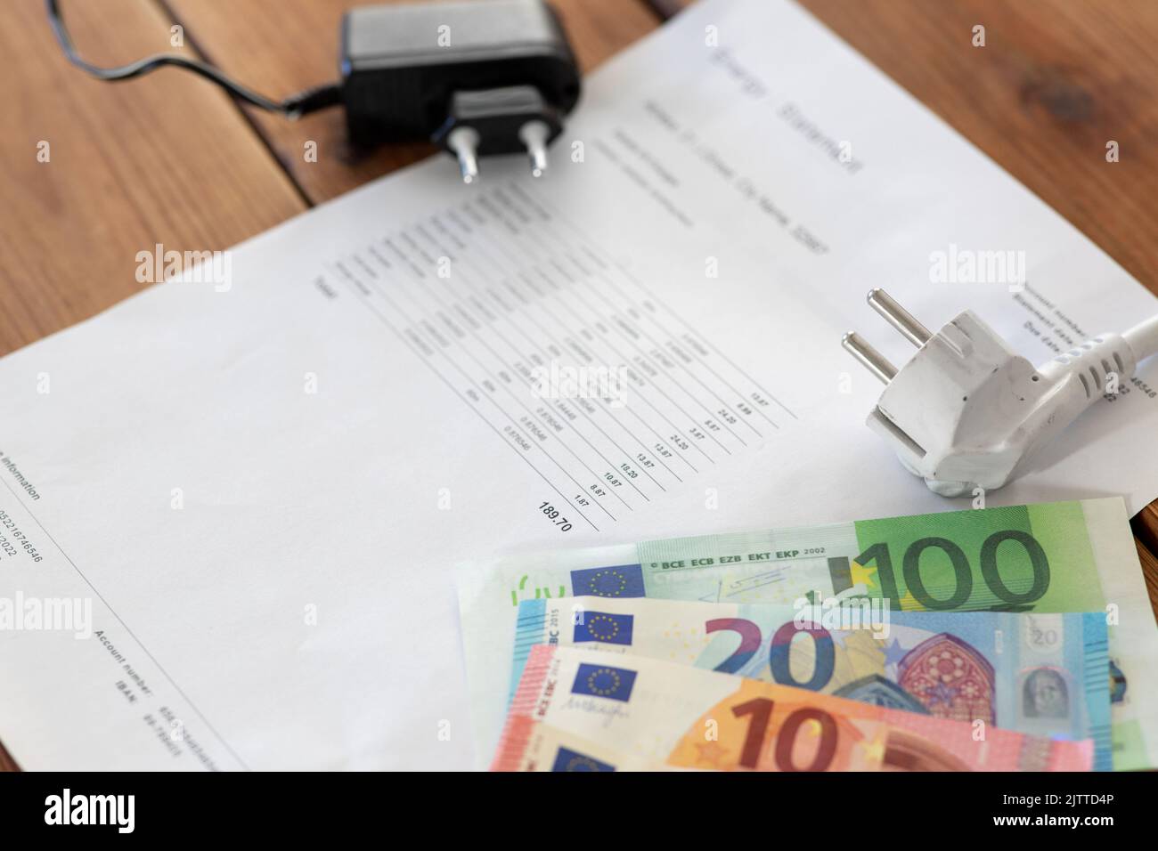 utility bill, money and electric plugs on table Stock Photo - Alamy