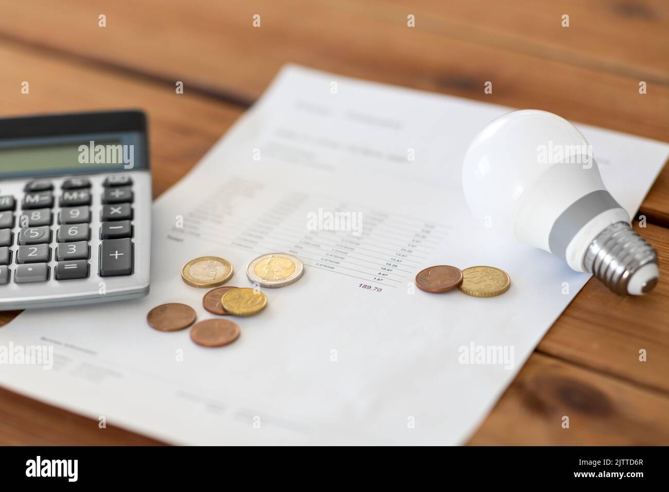 utility bill, calculator, money and lightbulb Stock Photo - Alamy