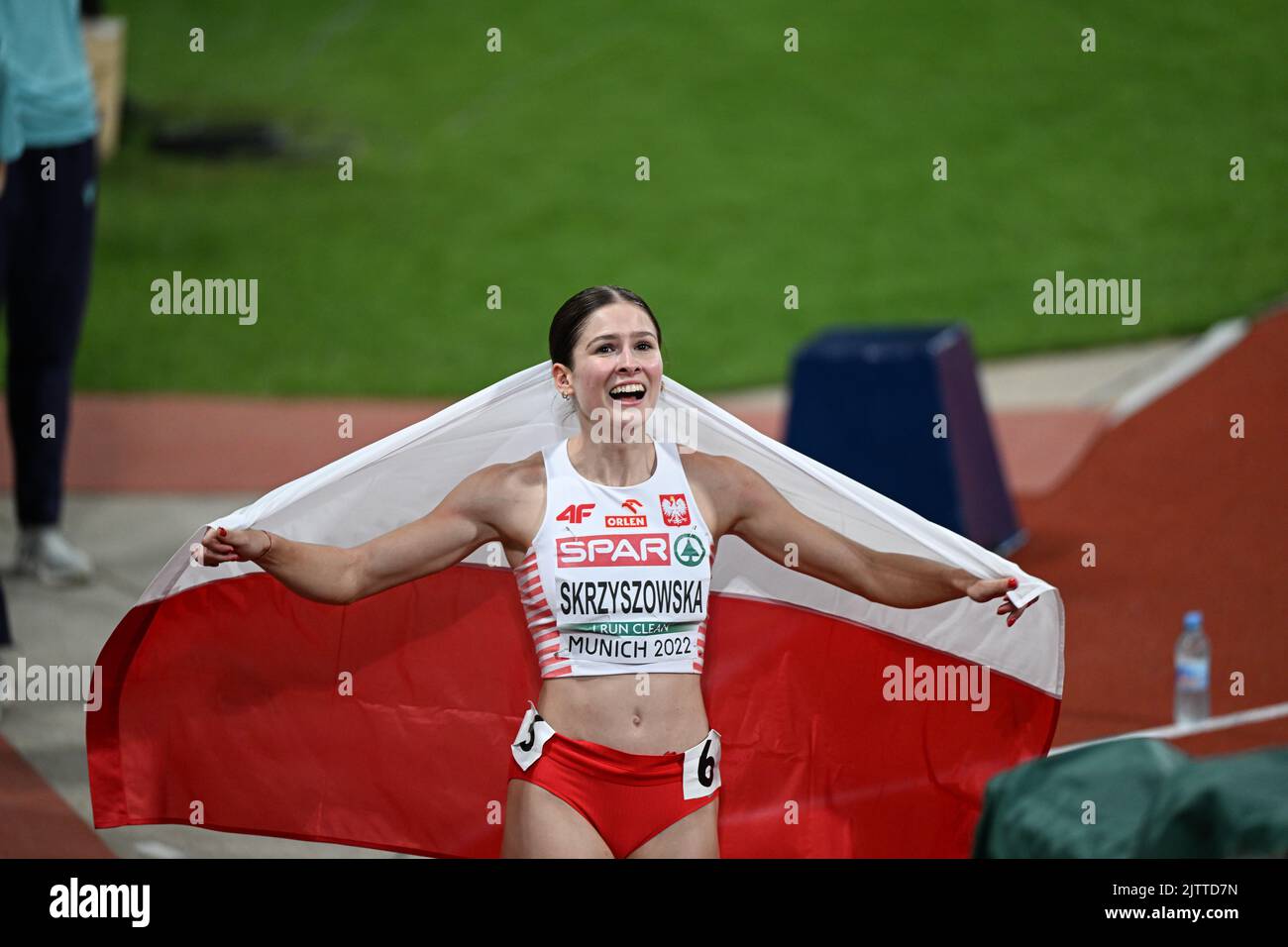 Pia Skrzyszowska with her country's flag as the winner of the 100 meters hurdles at the European ...