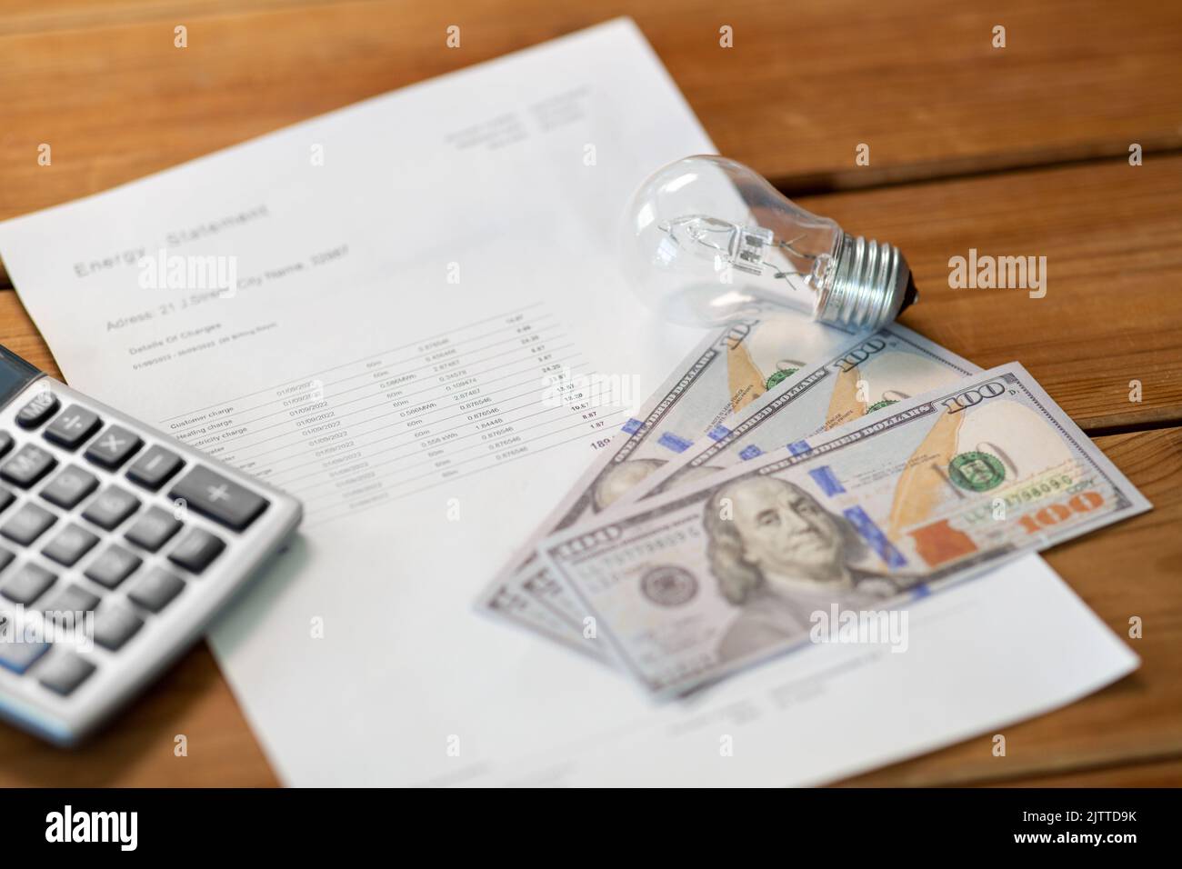 utility bill, calculator, money and lightbulb Stock Photo - Alamy