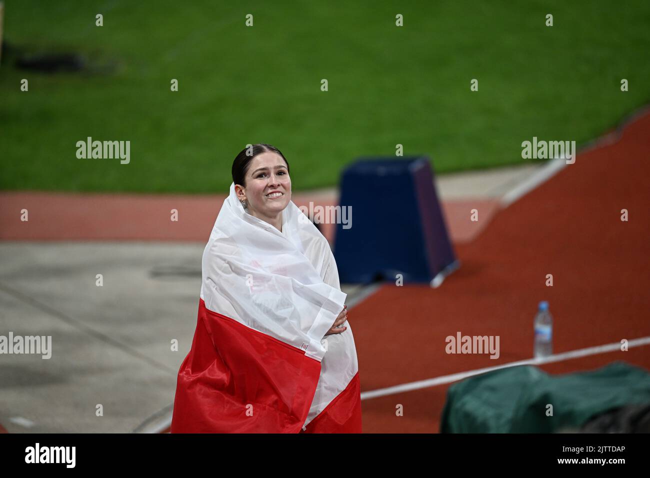 Pia Skrzyszowska with her country's flag as the winner of the 100 ...