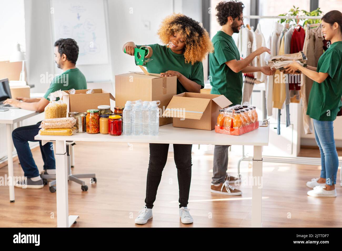 happy volunteers packing food in donation boxes Stock Photo - Alamy