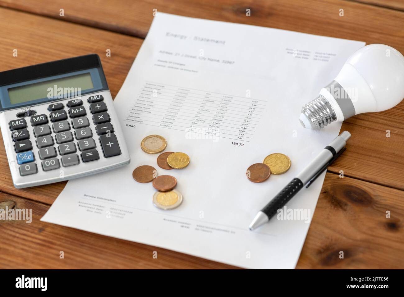 utility bill, calculator, money and lightbulb Stock Photo - Alamy