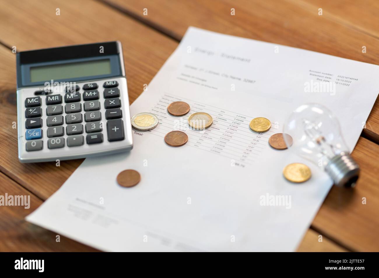 utility bill, calculator, money and lightbulb Stock Photo - Alamy
