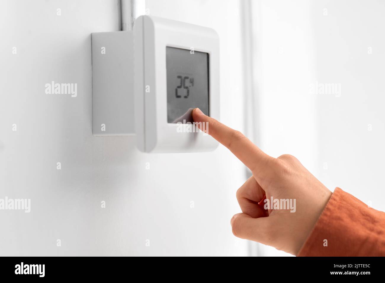 hand setting room temperature on sensor at home Stock Photo - Alamy