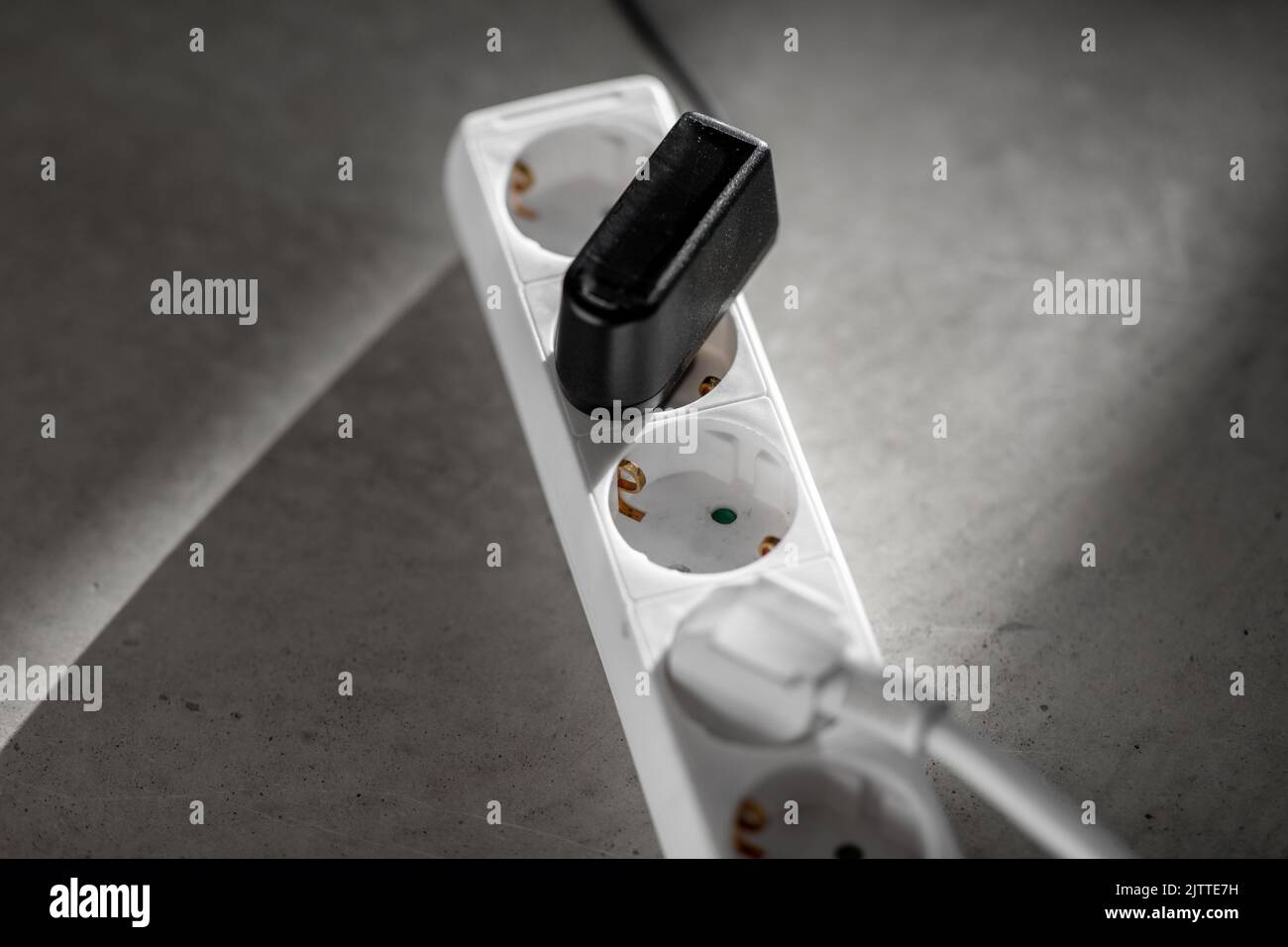 close up of socket with plugs and charger on floor Stock Photo - Alamy