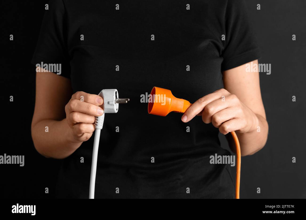Woman inserting plug electric hi-res stock photography and images - Alamy