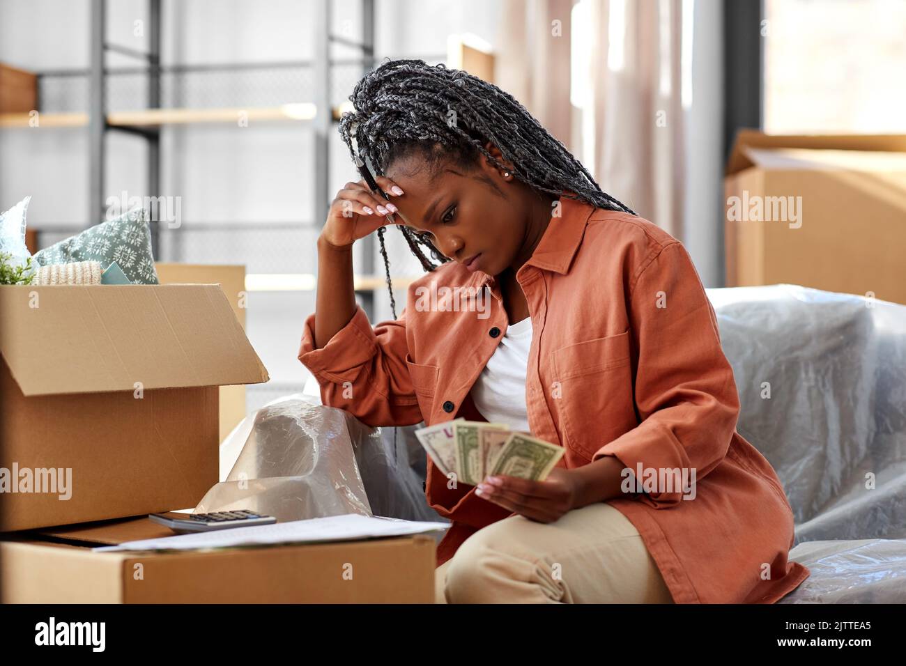 woman moving to new home and counting money Stock Photo - Alamy