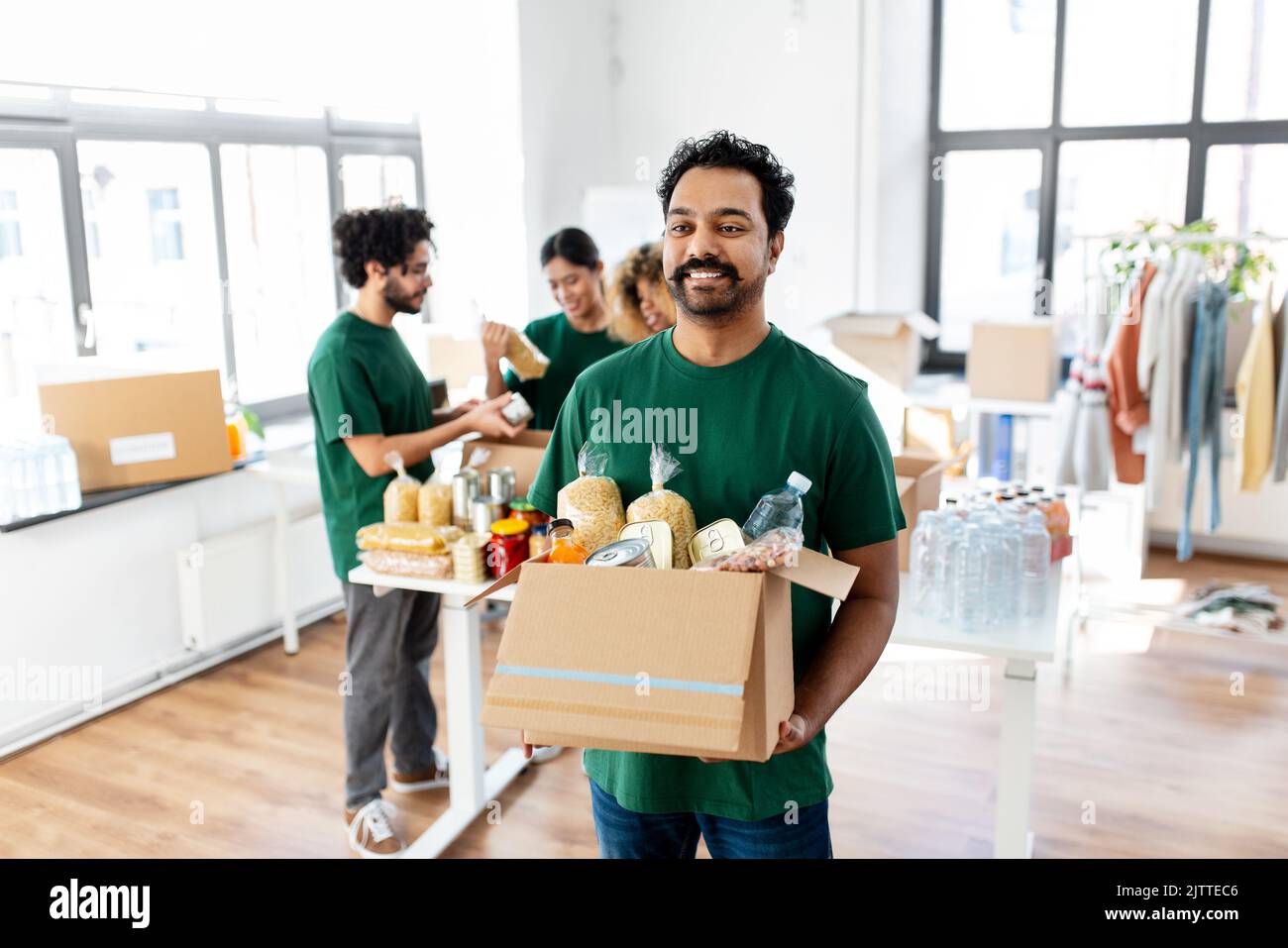 happy volunteers packing food in donation boxes Stock Photo - Alamy